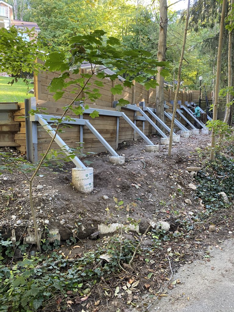 Wood retaining wall on a slope - JW Portable Welding & Repairs