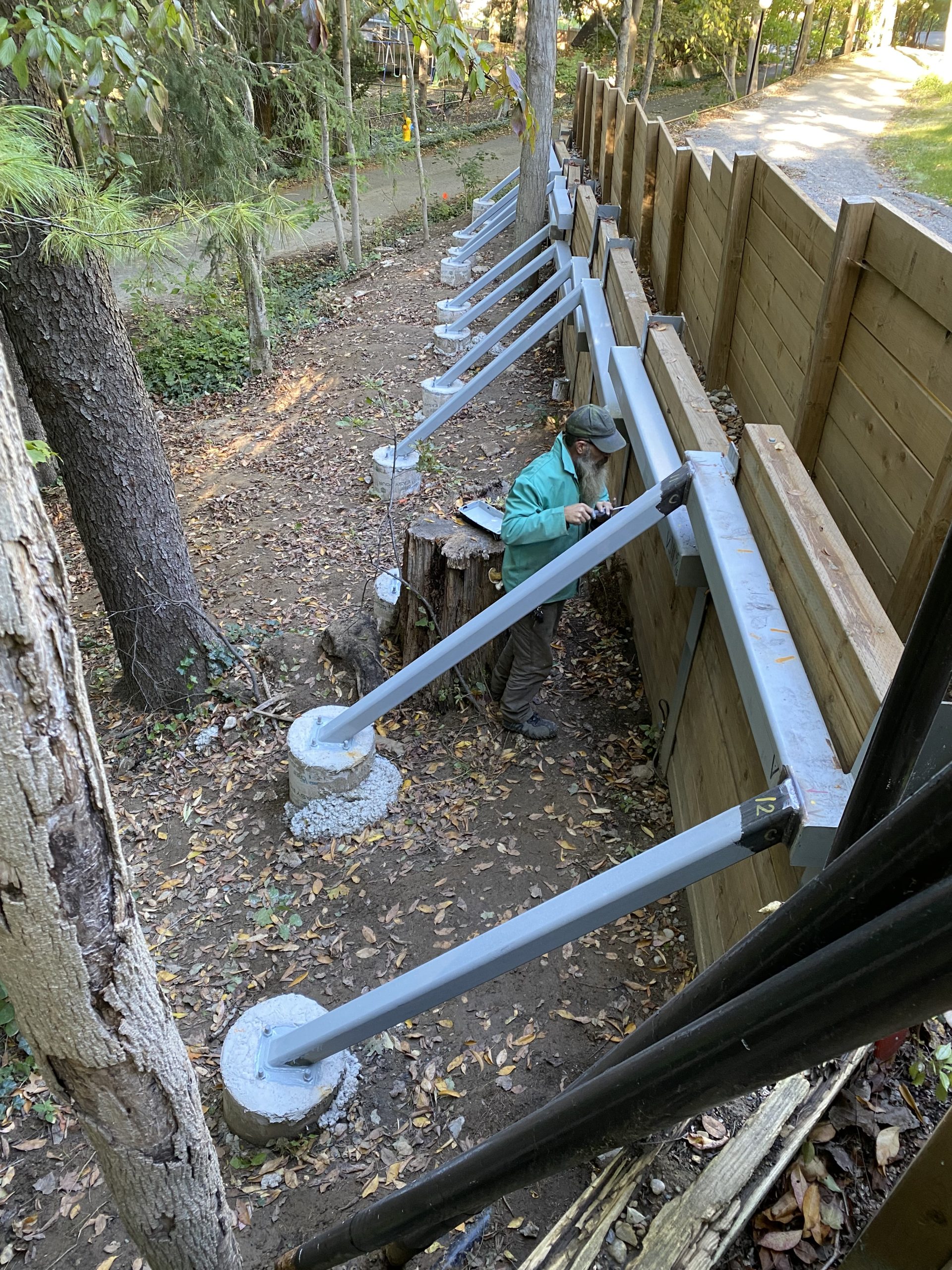 Wood retaining wall on a slope - JW Portable Welding & Repairs